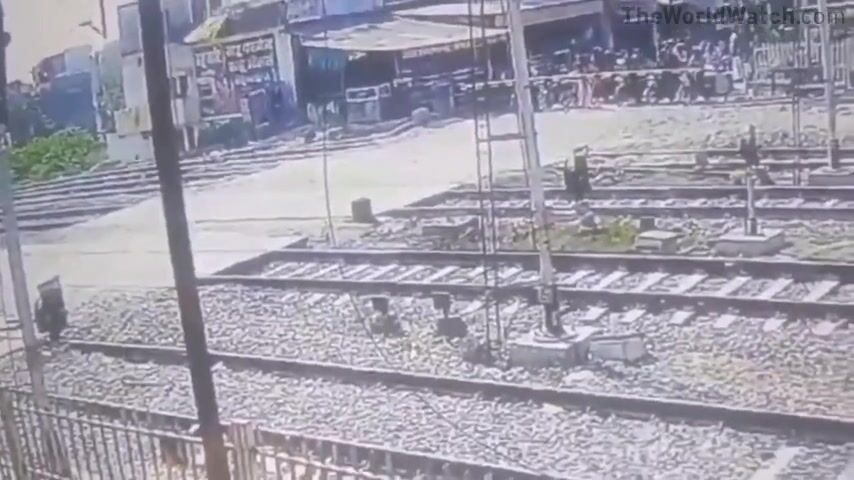 Confused Female College Student Pushing Bicycle Across Railroad Tracks